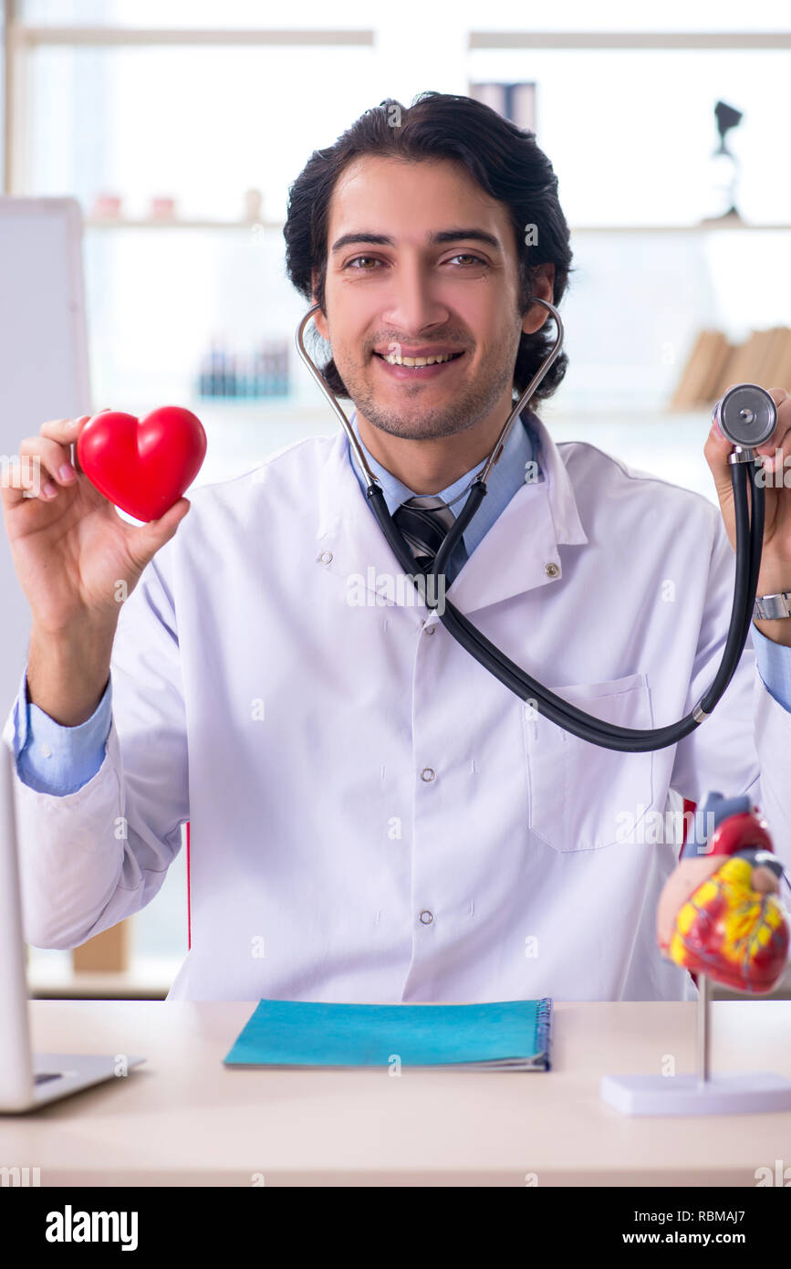 Young handsome doctor cardiologist in front of whiteboard Stock Photo ...