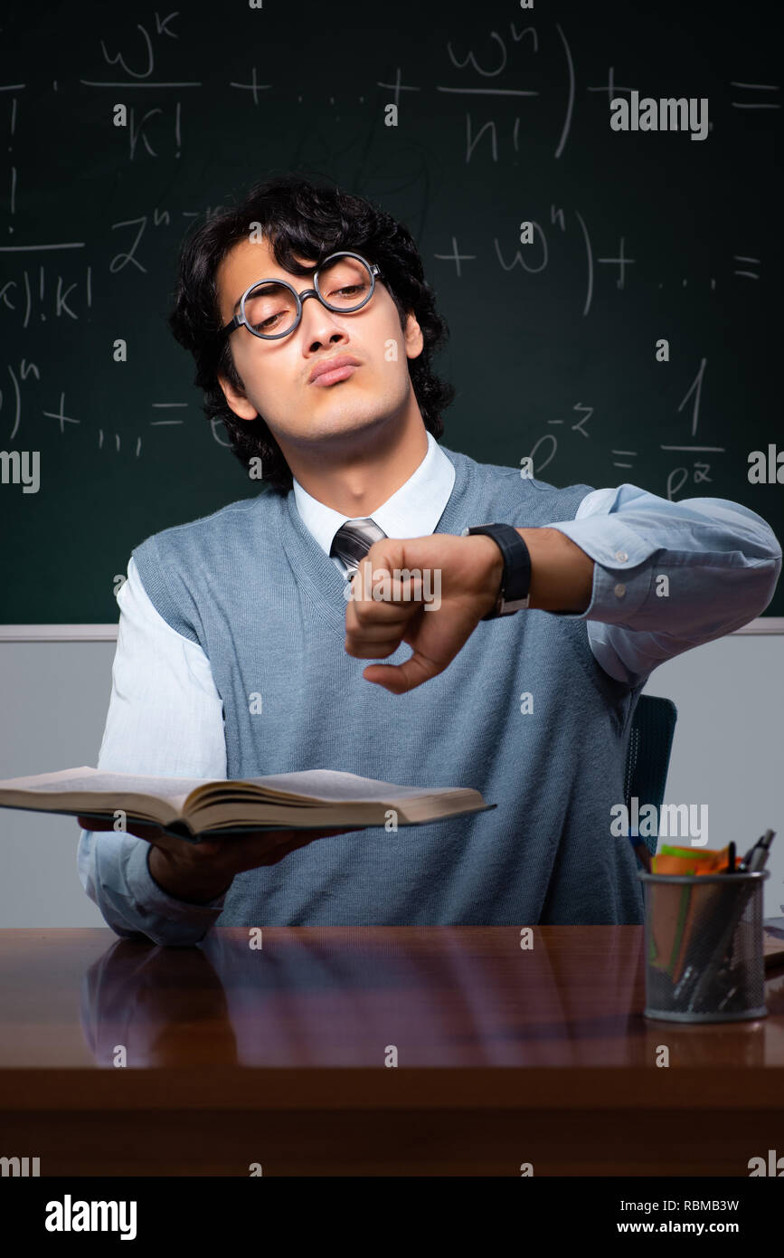 Young math teacher in front of chalkboard Stock Photo - Alamy