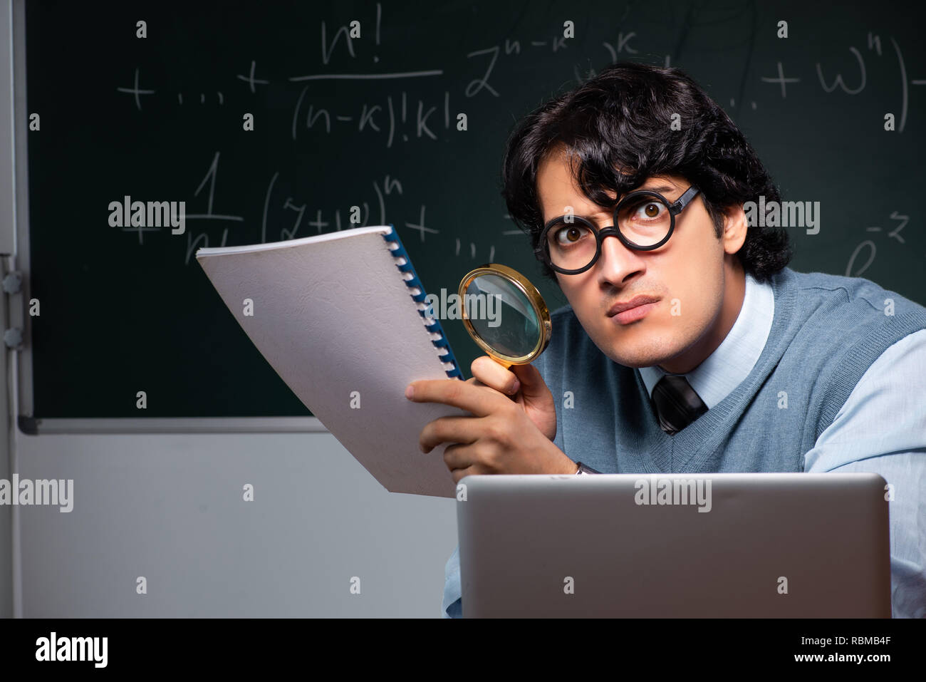 Young math teacher in front of chalkboard Stock Photo - Alamy