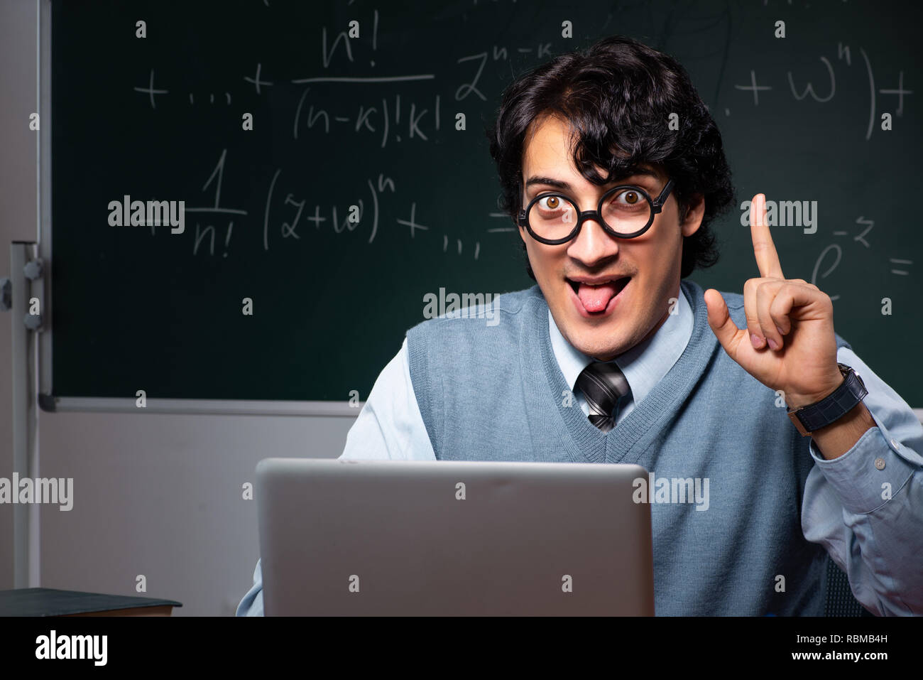 Young math teacher in front of chalkboard Stock Photo - Alamy