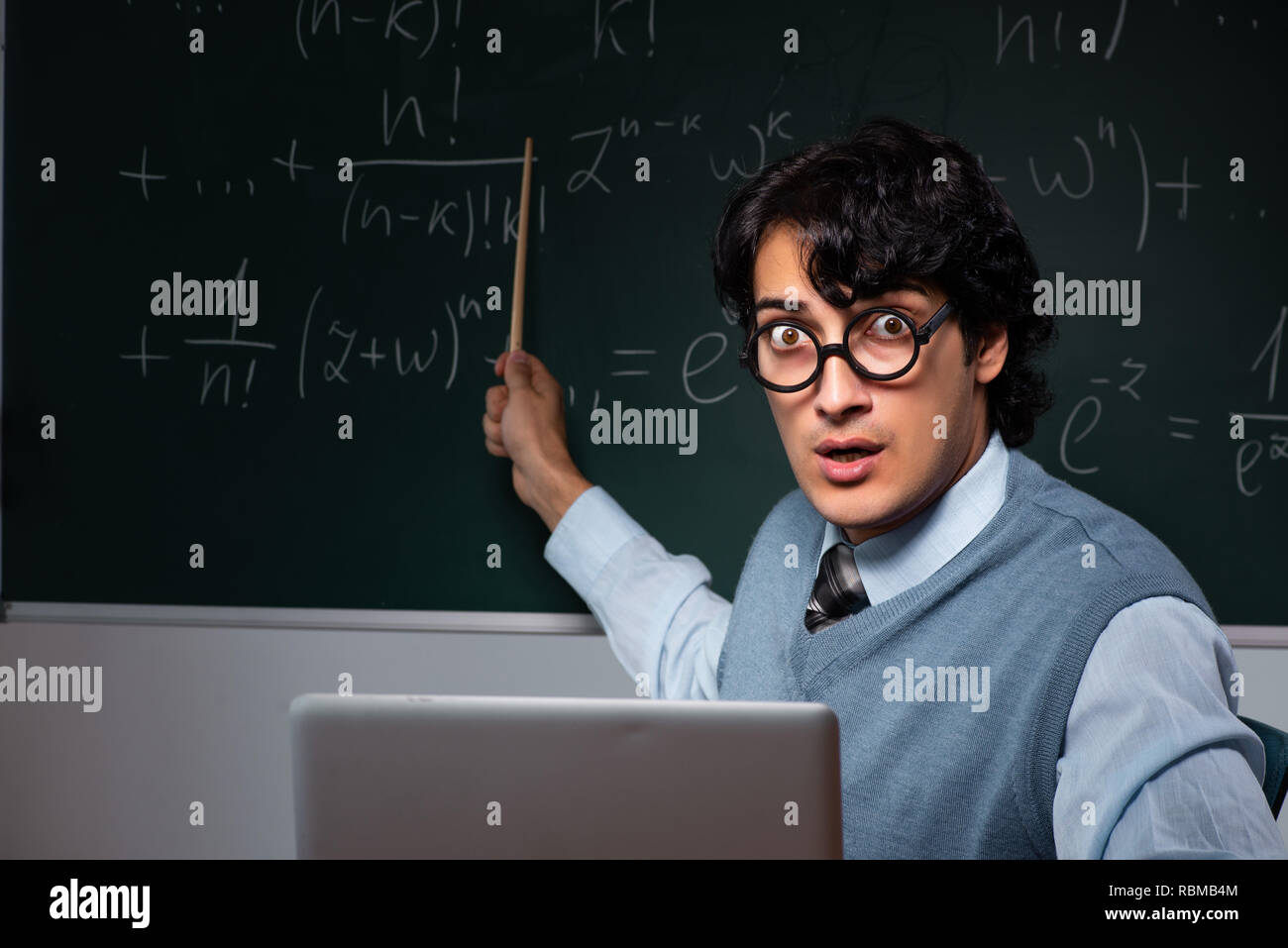 Young math teacher in front of chalkboard Stock Photo - Alamy