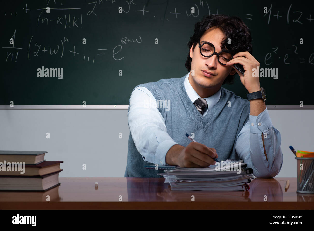 Young math teacher in front of chalkboard Stock Photo - Alamy