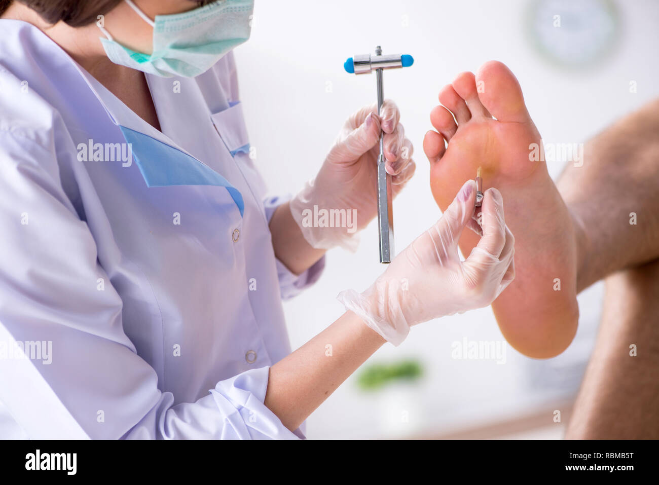 Podiatrist treating feet during procedure Stock Photo - Alamy