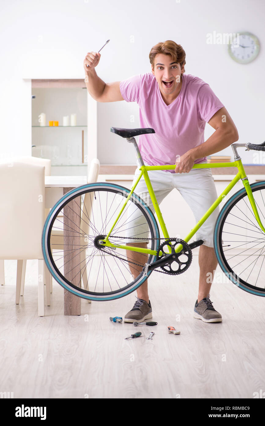 Man repairing his broken bicycle Stock Photo - Alamy