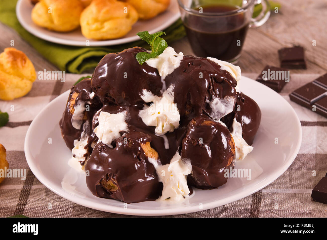 Chocolate profiteroles with chantilly cream hi-res stock photography ...