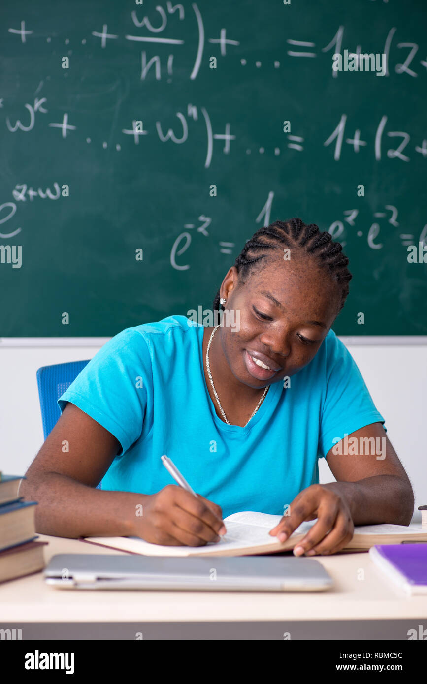Black female student in front of chalkboard Stock Photo - Alamy
