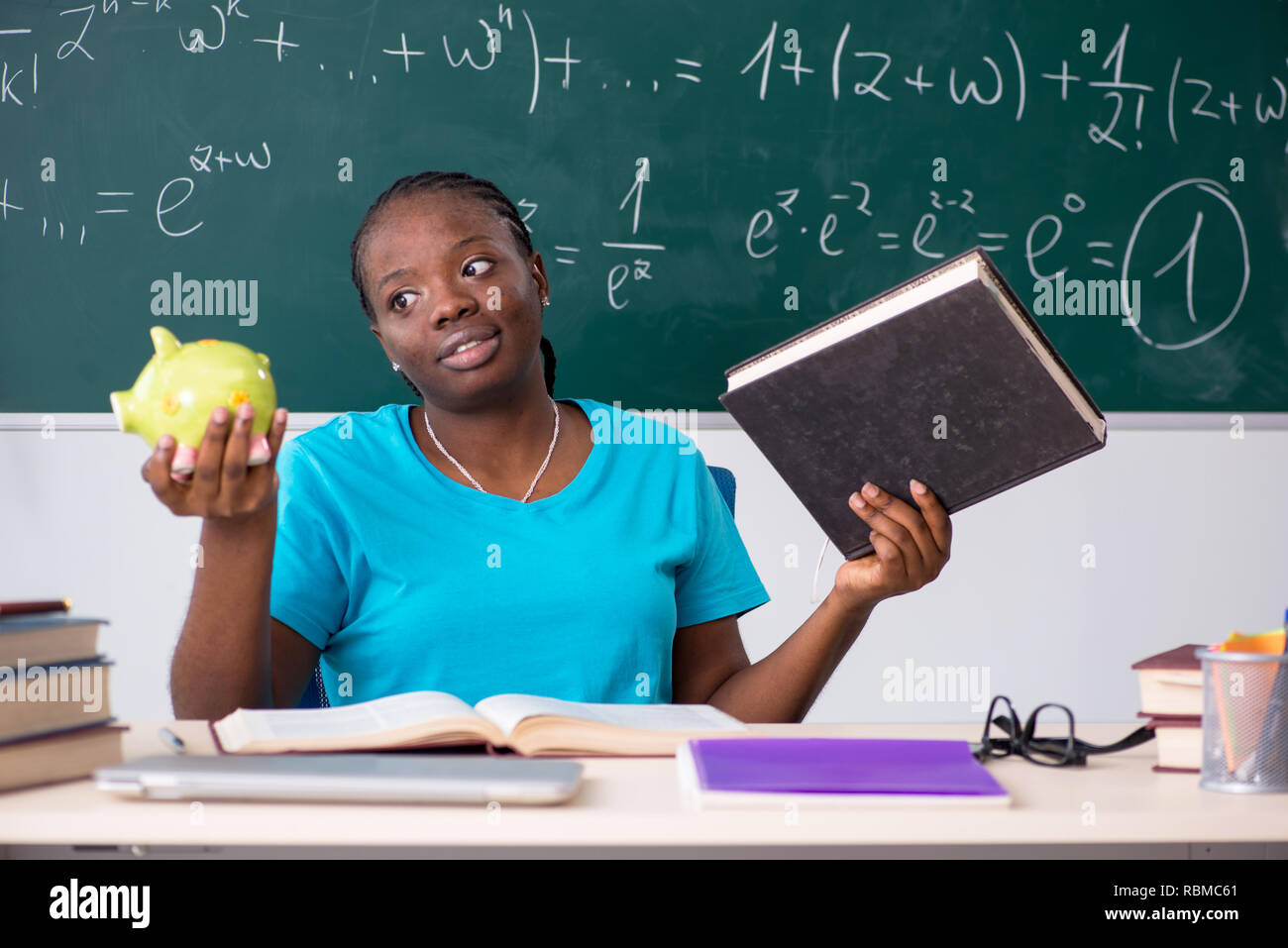 Black female student in front of chalkboard Stock Photo - Alamy