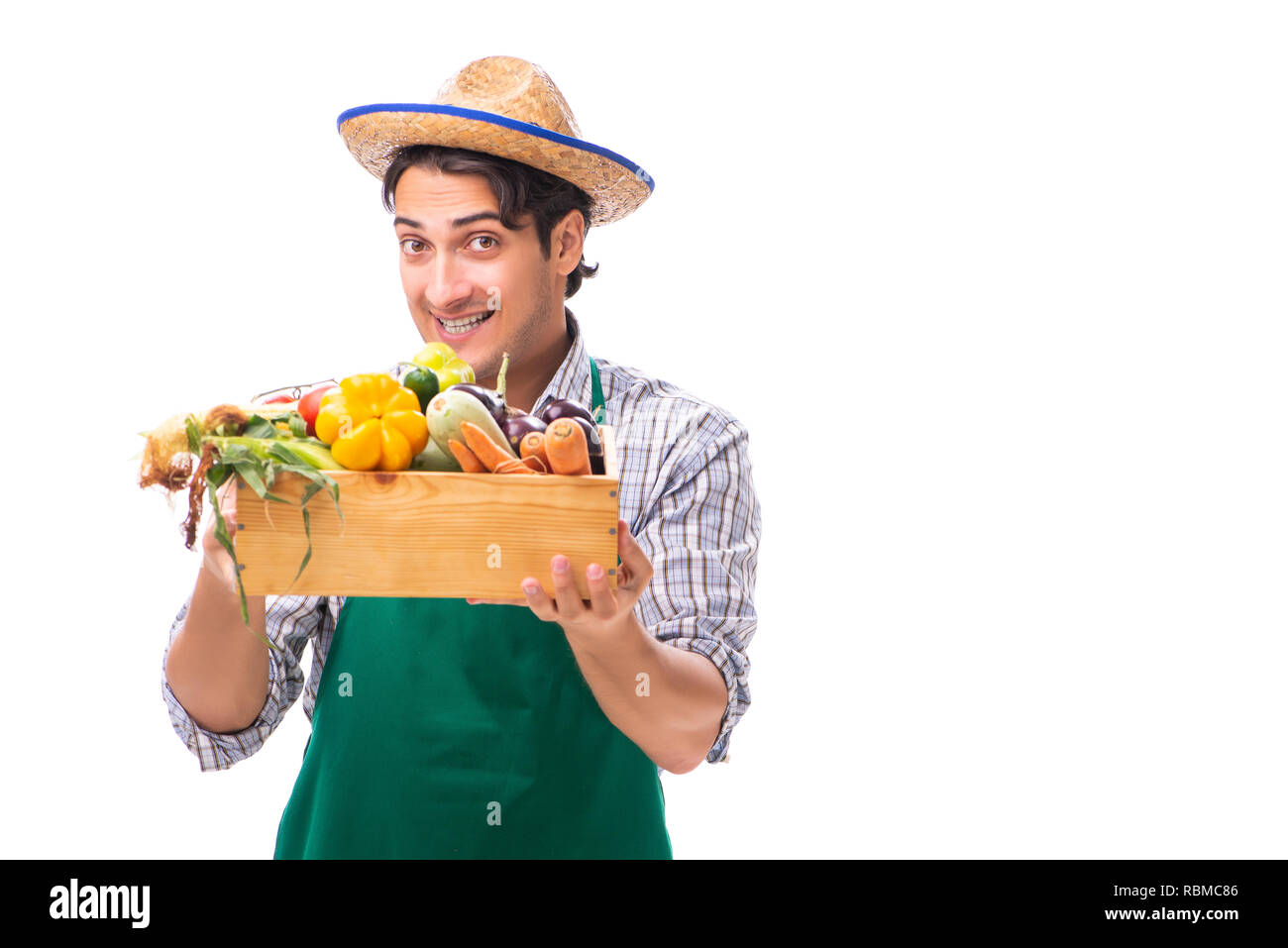 Young farmer with fresh produce isolated on white background Stock ...