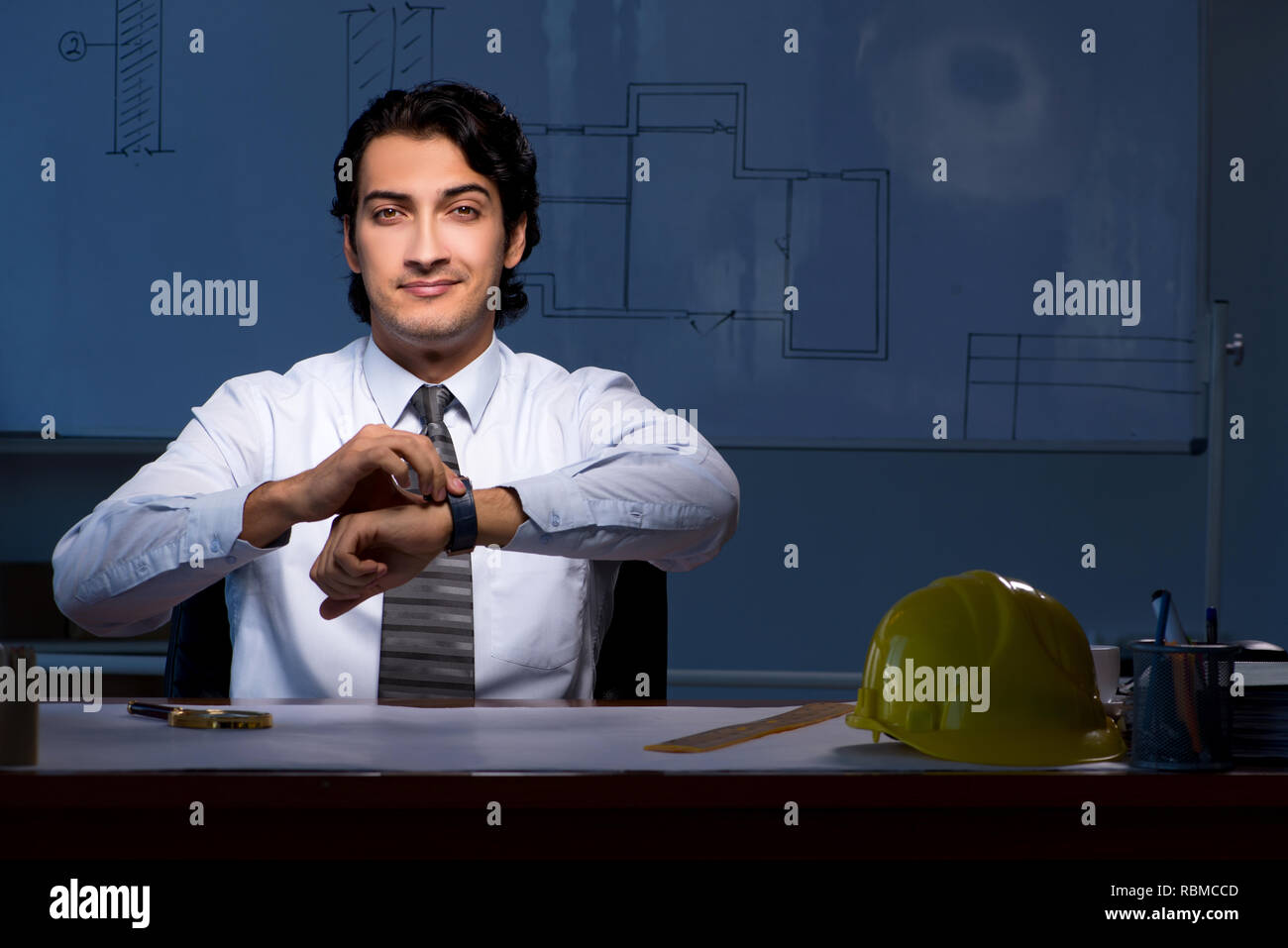 Young construction architect working on project at night Stock Photo ...