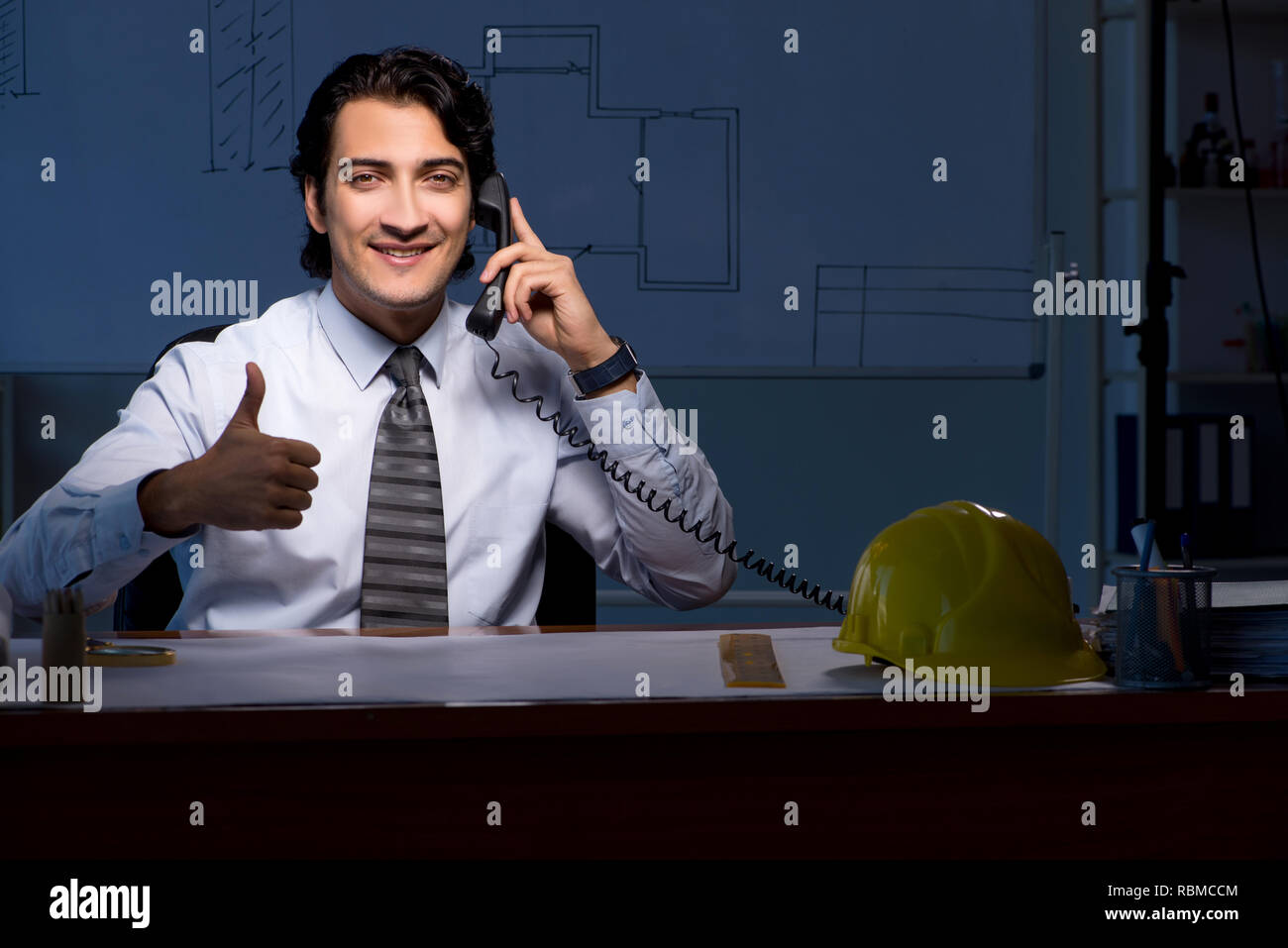 Young construction architect working on project at night Stock Photo ...