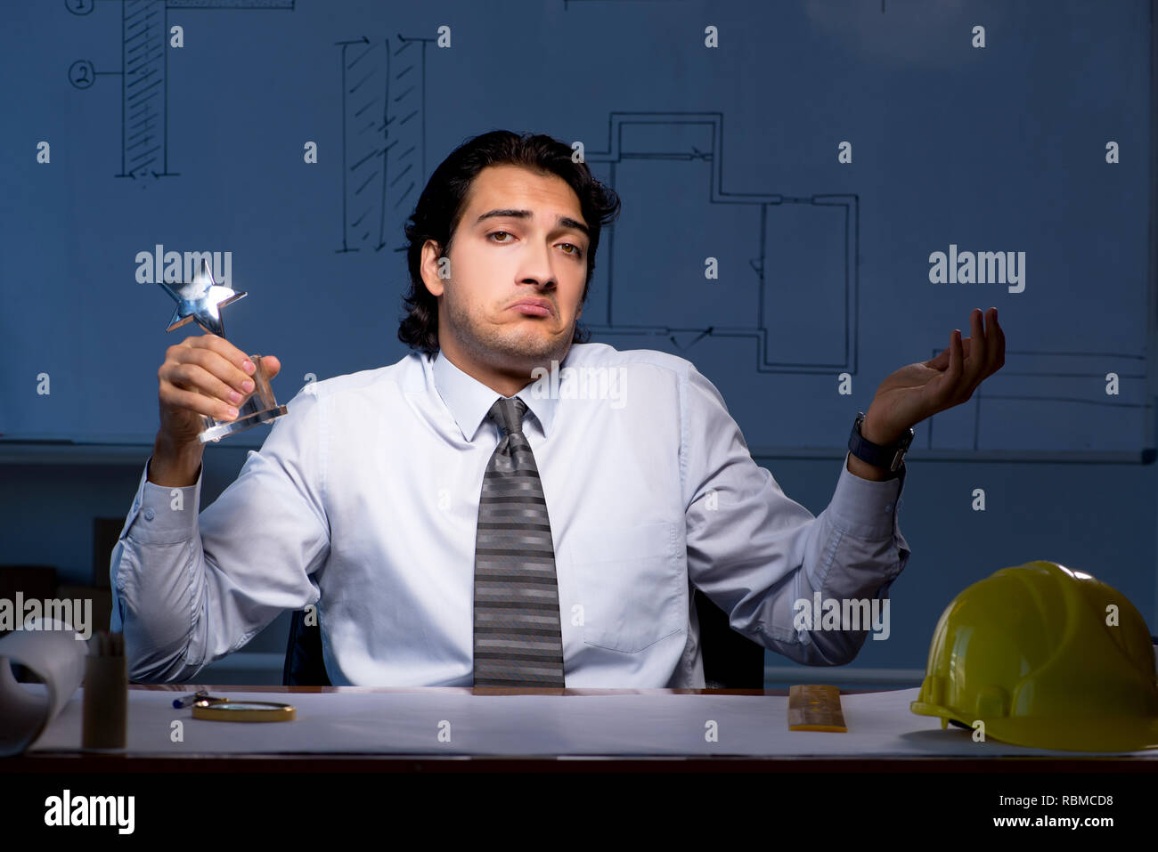 Young construction architect working on project at night Stock Photo ...