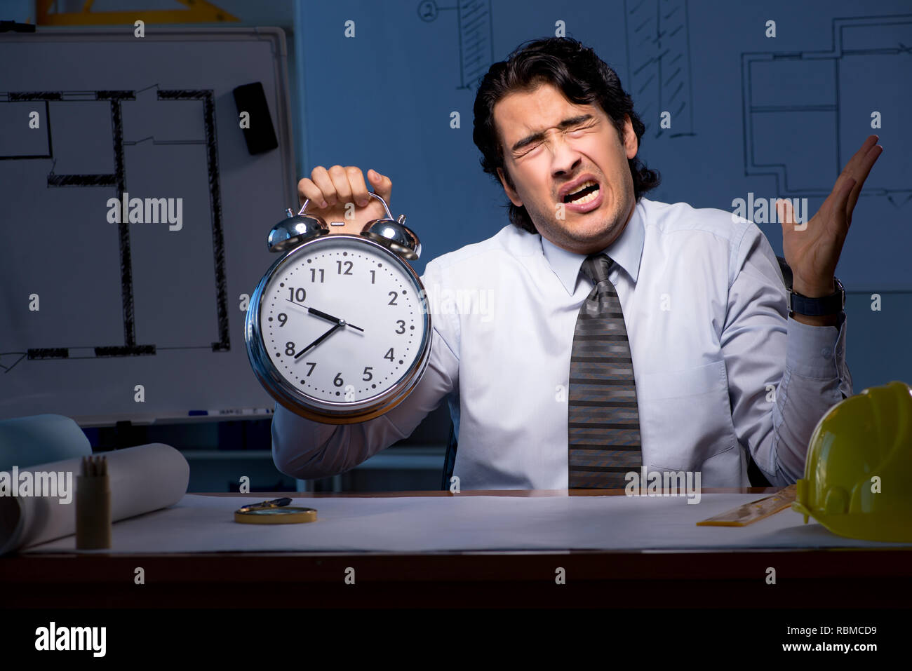 Young construction architect working on project at night Stock Photo ...