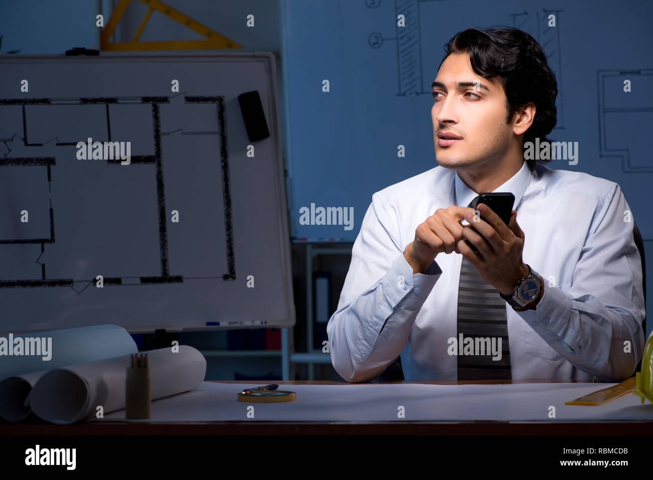 Young construction architect working on project at night Stock Photo ...