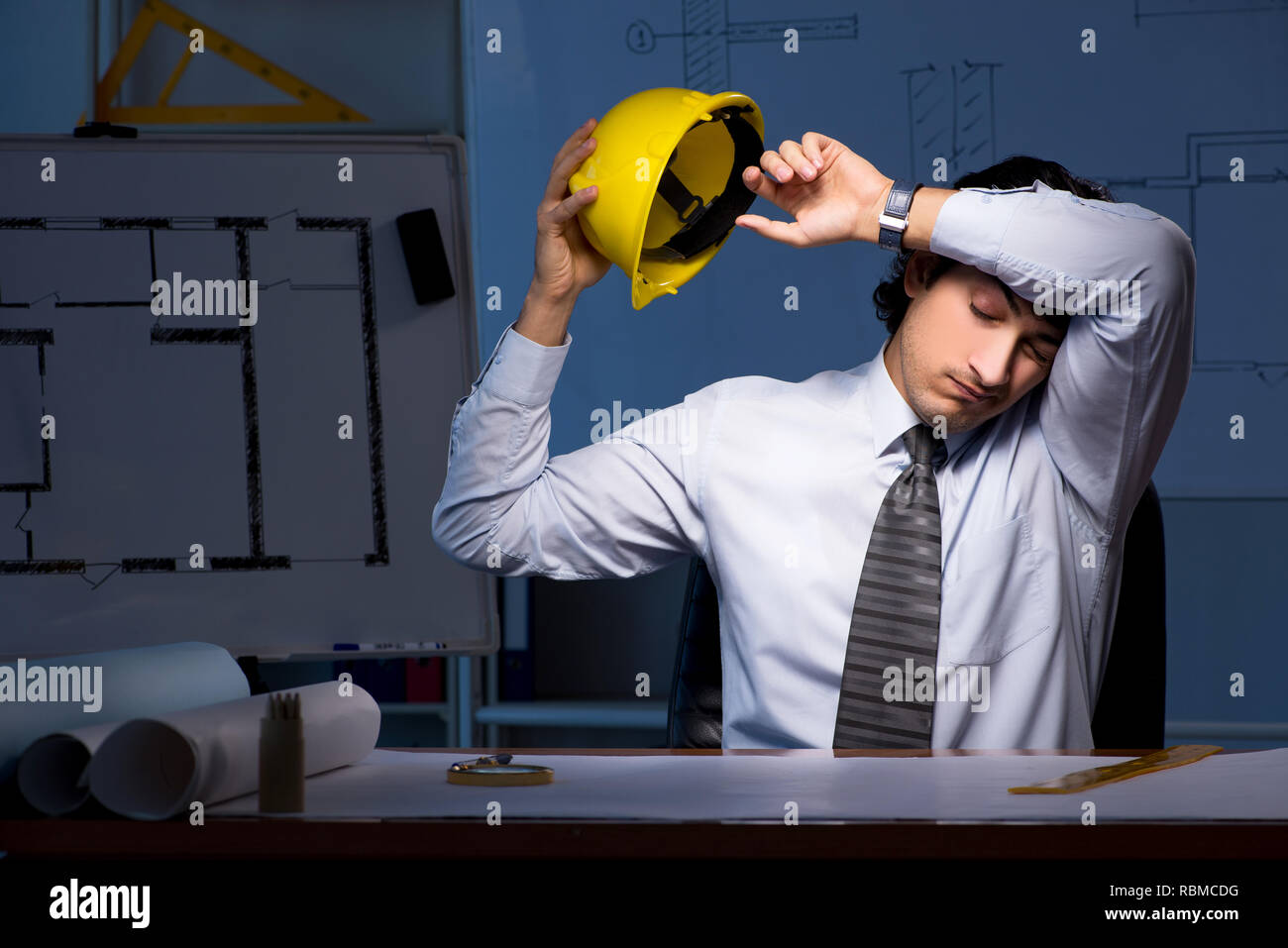 Young construction architect working on project at night Stock Photo ...