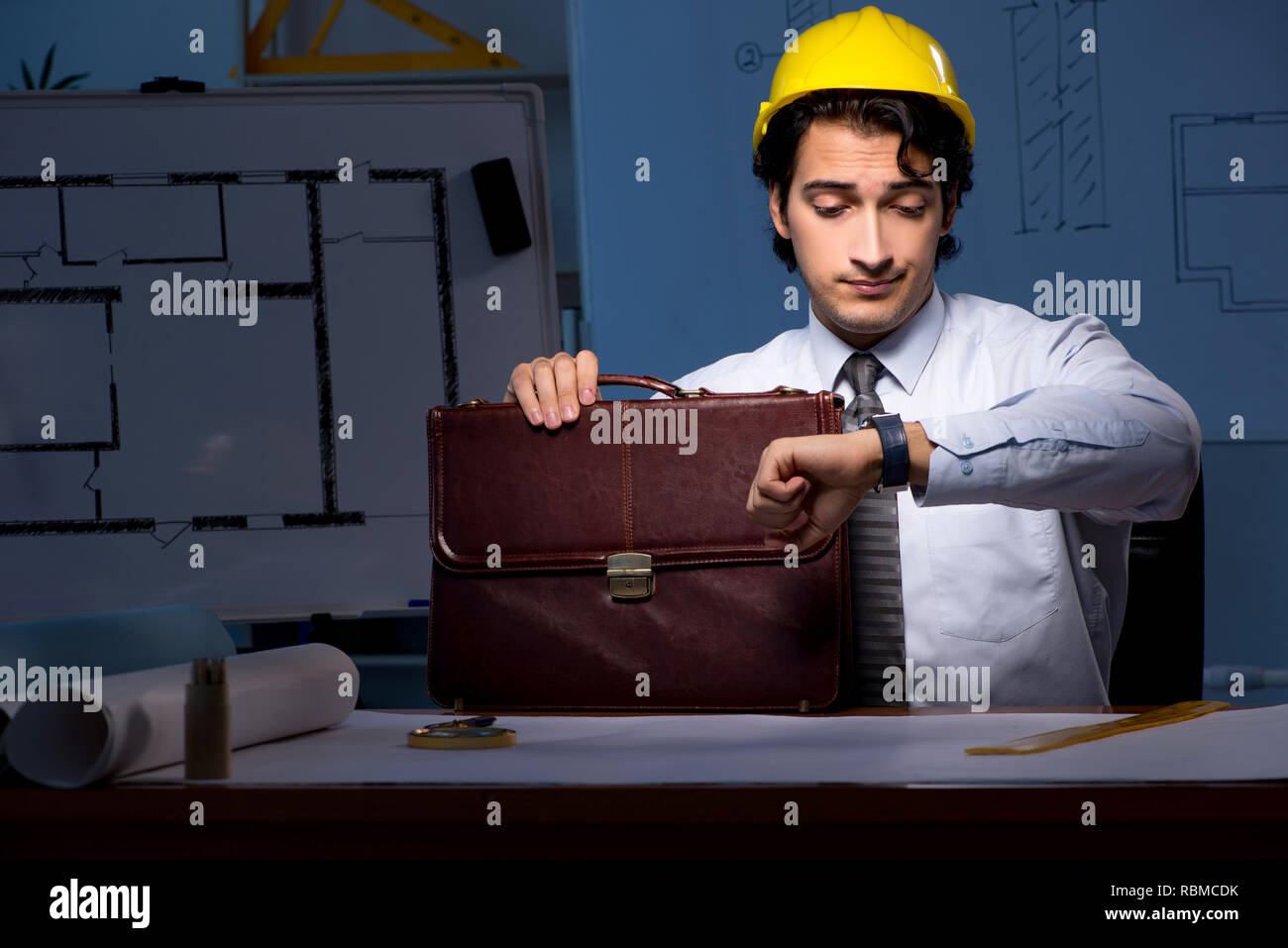Young construction architect working on project at night Stock Photo ...