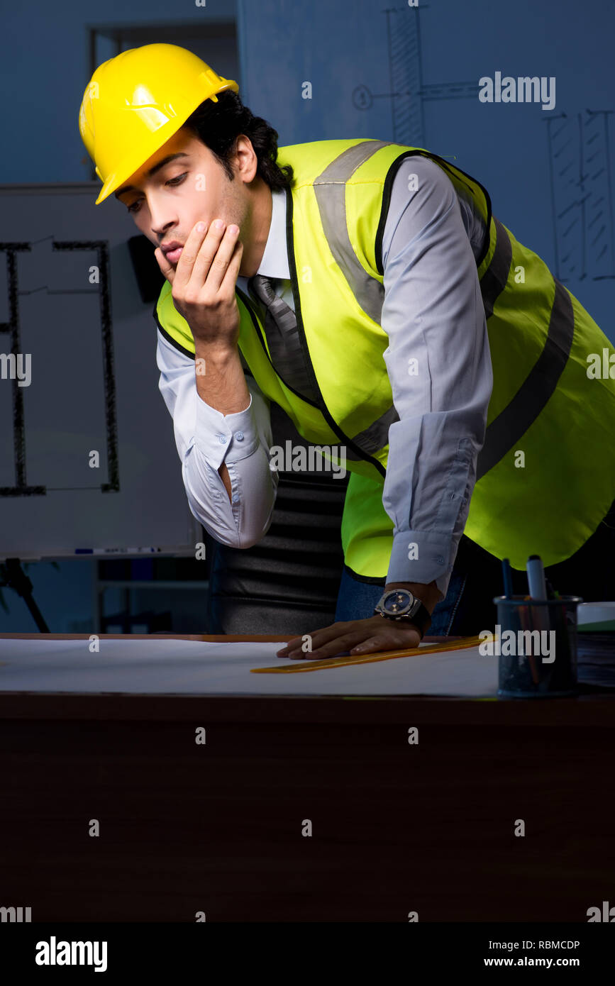 Young construction architect working on project at night Stock Photo ...