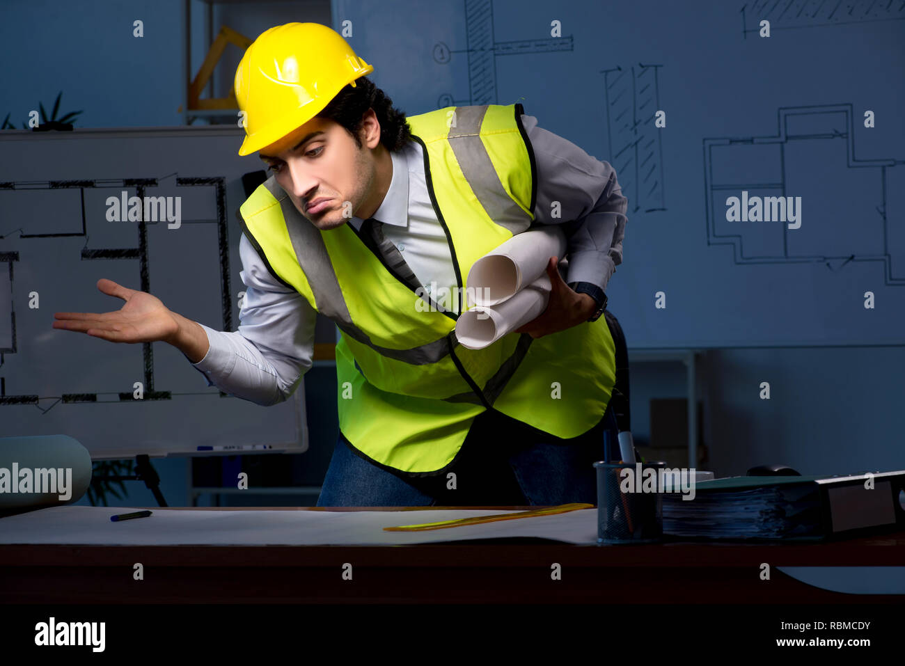 Young construction architect working on project at night Stock Photo ...