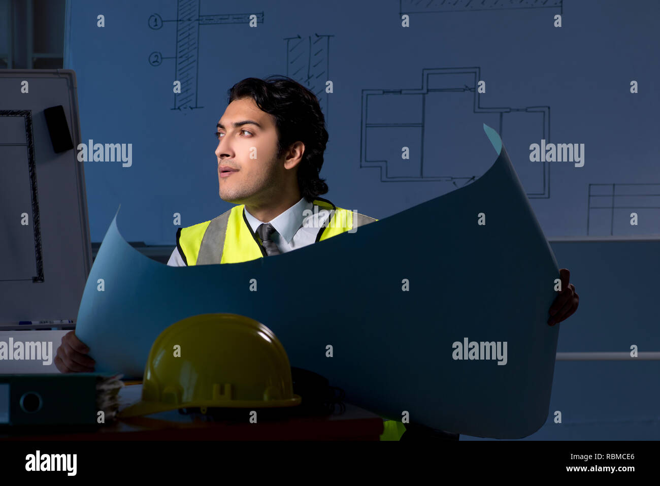 Young construction architect working on project at night Stock Photo ...