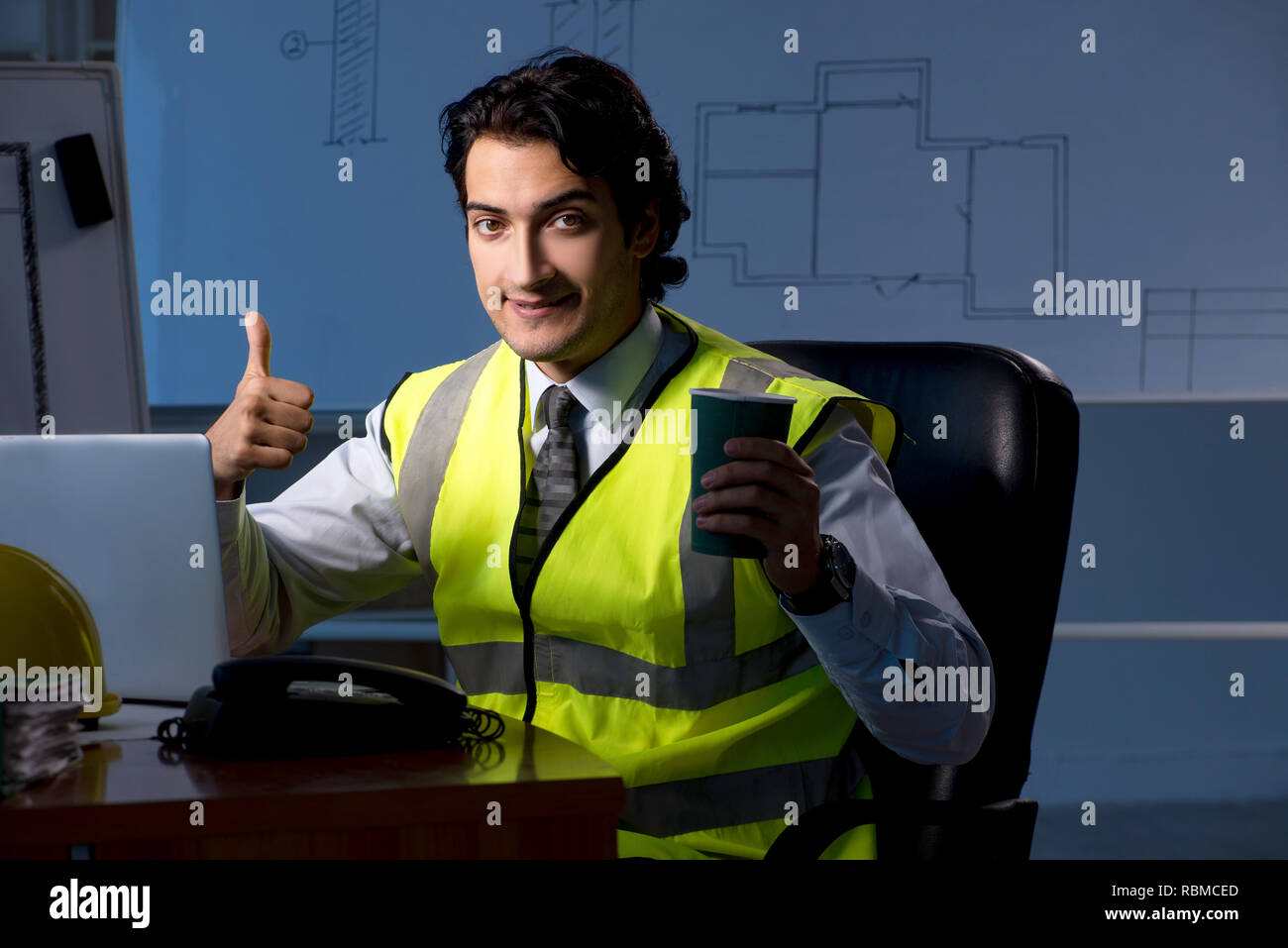 Young construction architect working on project at night Stock Photo ...