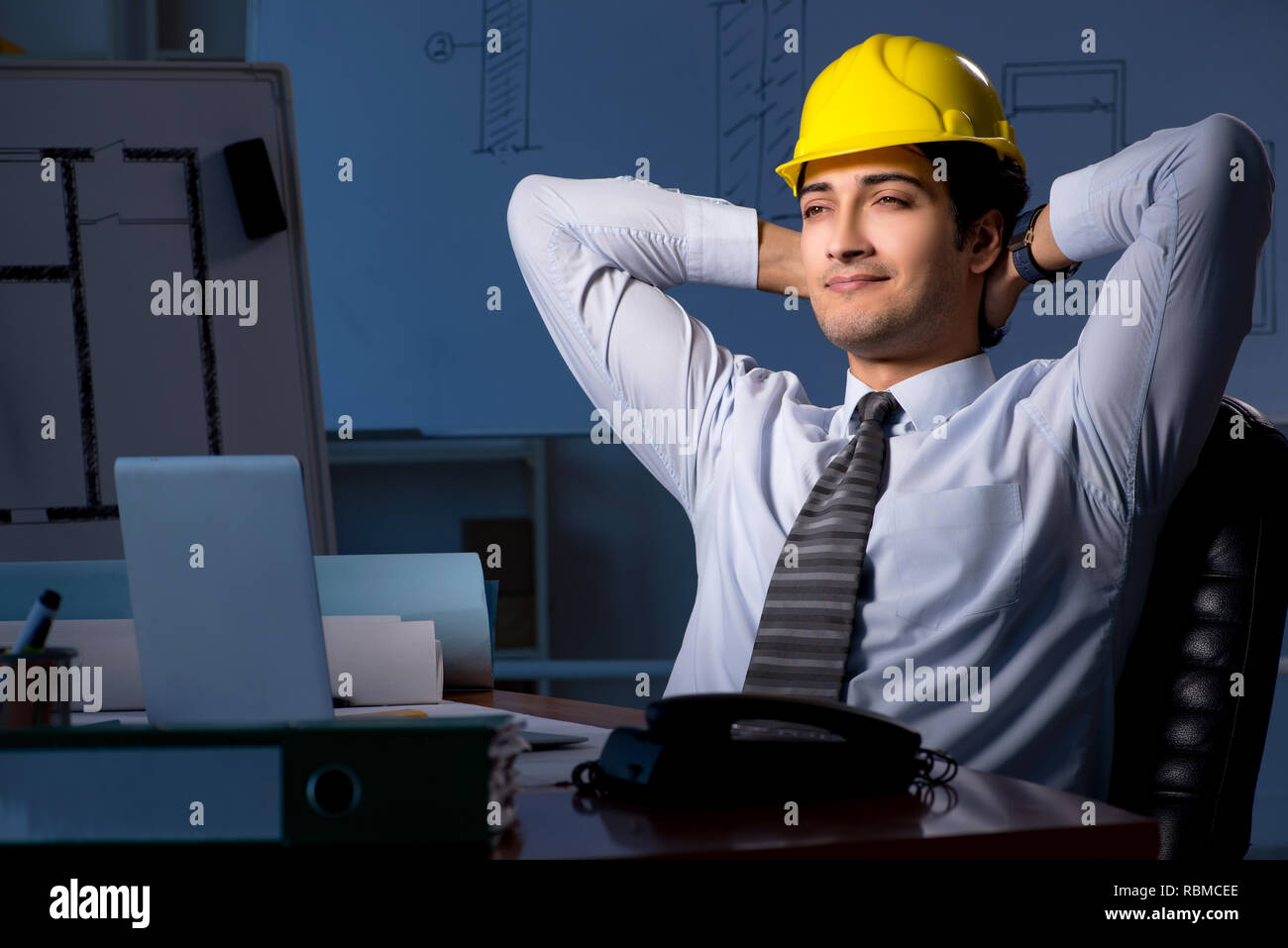 Young construction architect working on project at night Stock Photo ...