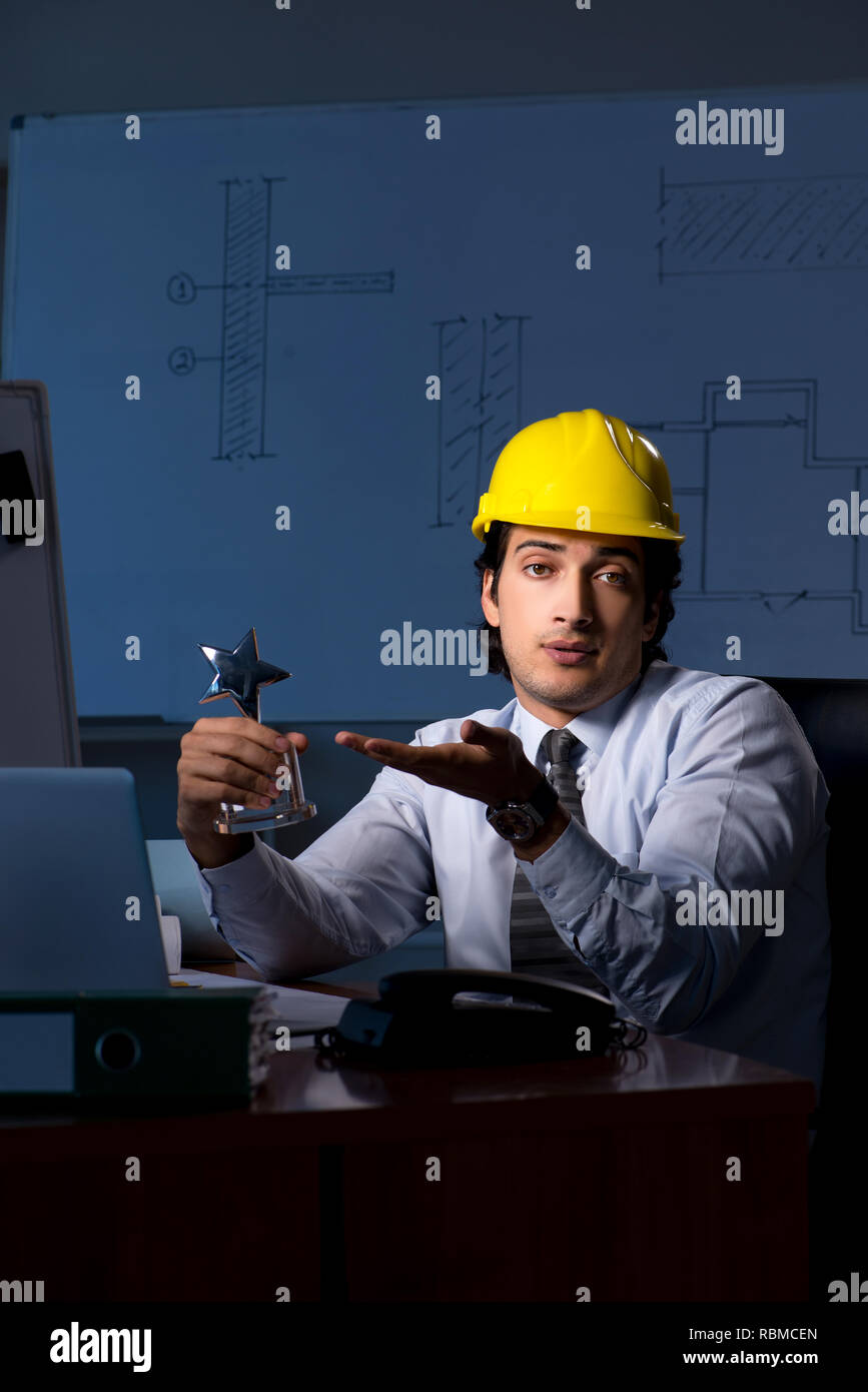 Young construction architect working on project at night Stock Photo ...