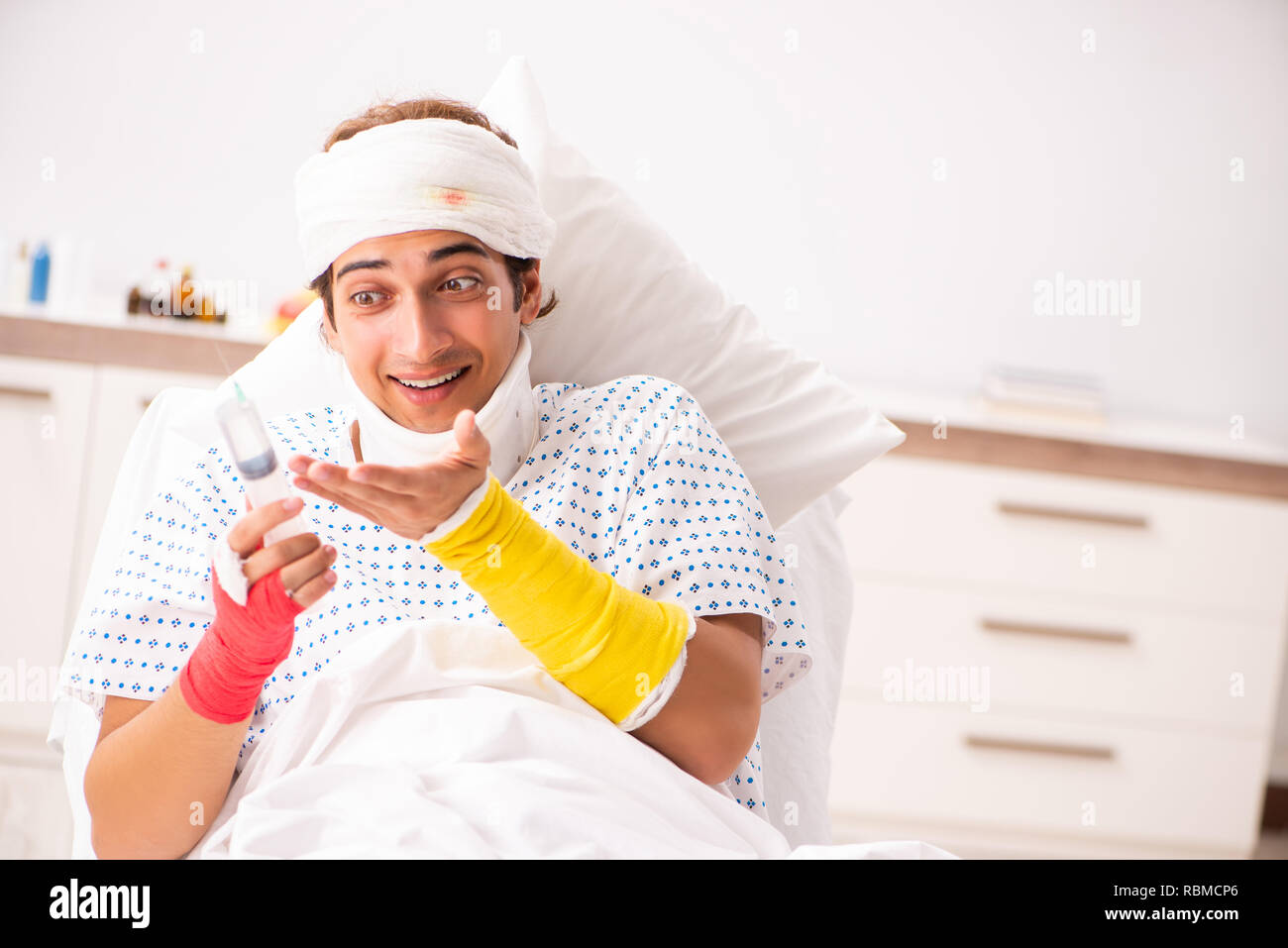 Young doctor examining injured patient Stock Photo - Alamy