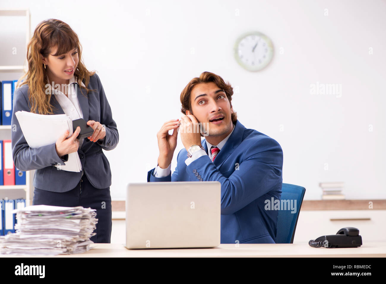 Deaf employee using hearing aid talking to boss Stock Photo - Alamy
