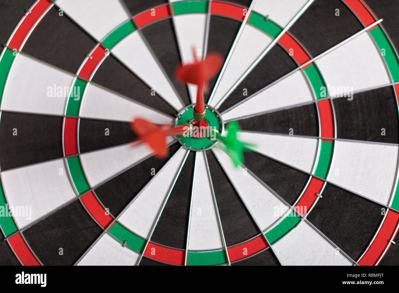 Three Darts hit red target on the target right close-up Stock Photo - Alamy