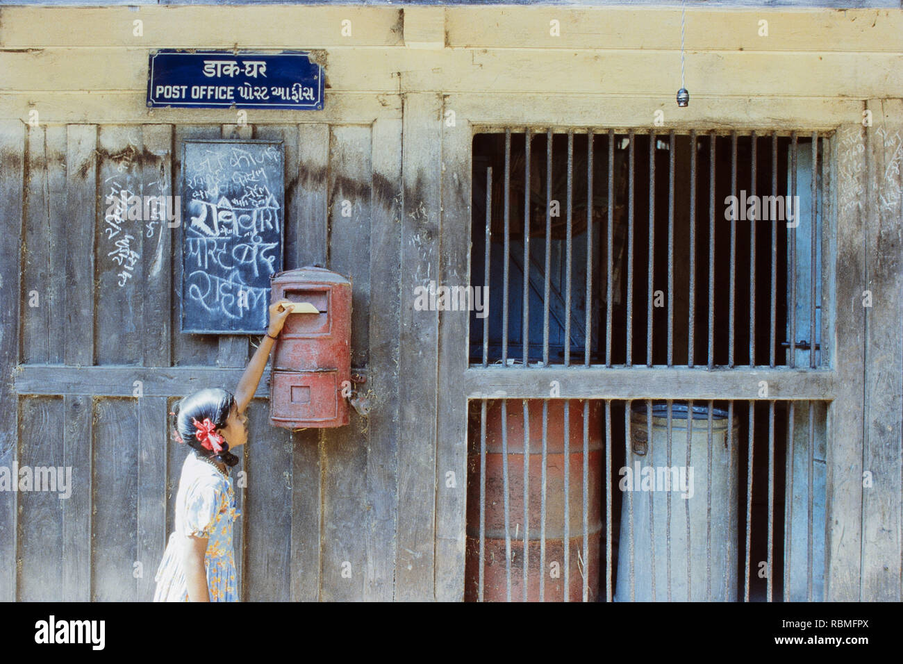 Girl posting letter in letterbox, Nere Village, Panvel, Maharashtra ...
