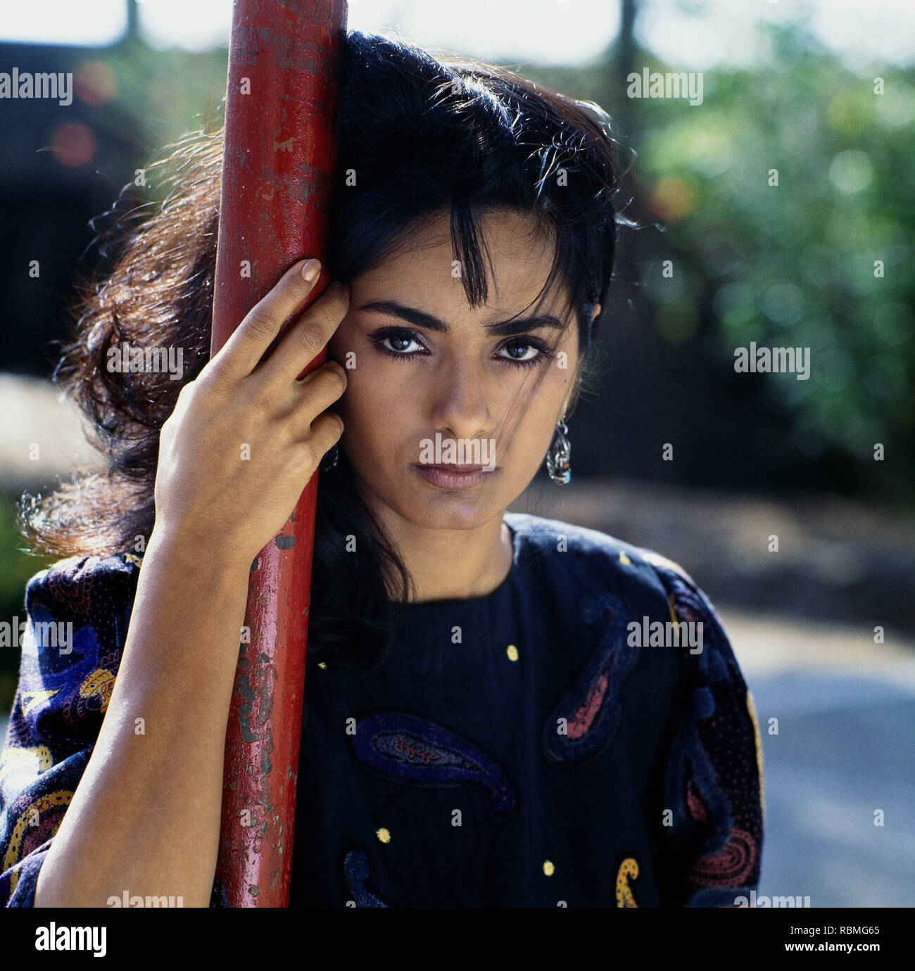 Portrait of Kitu Gidwani leaning on pole, India, Asia Stock Photo - Alamy