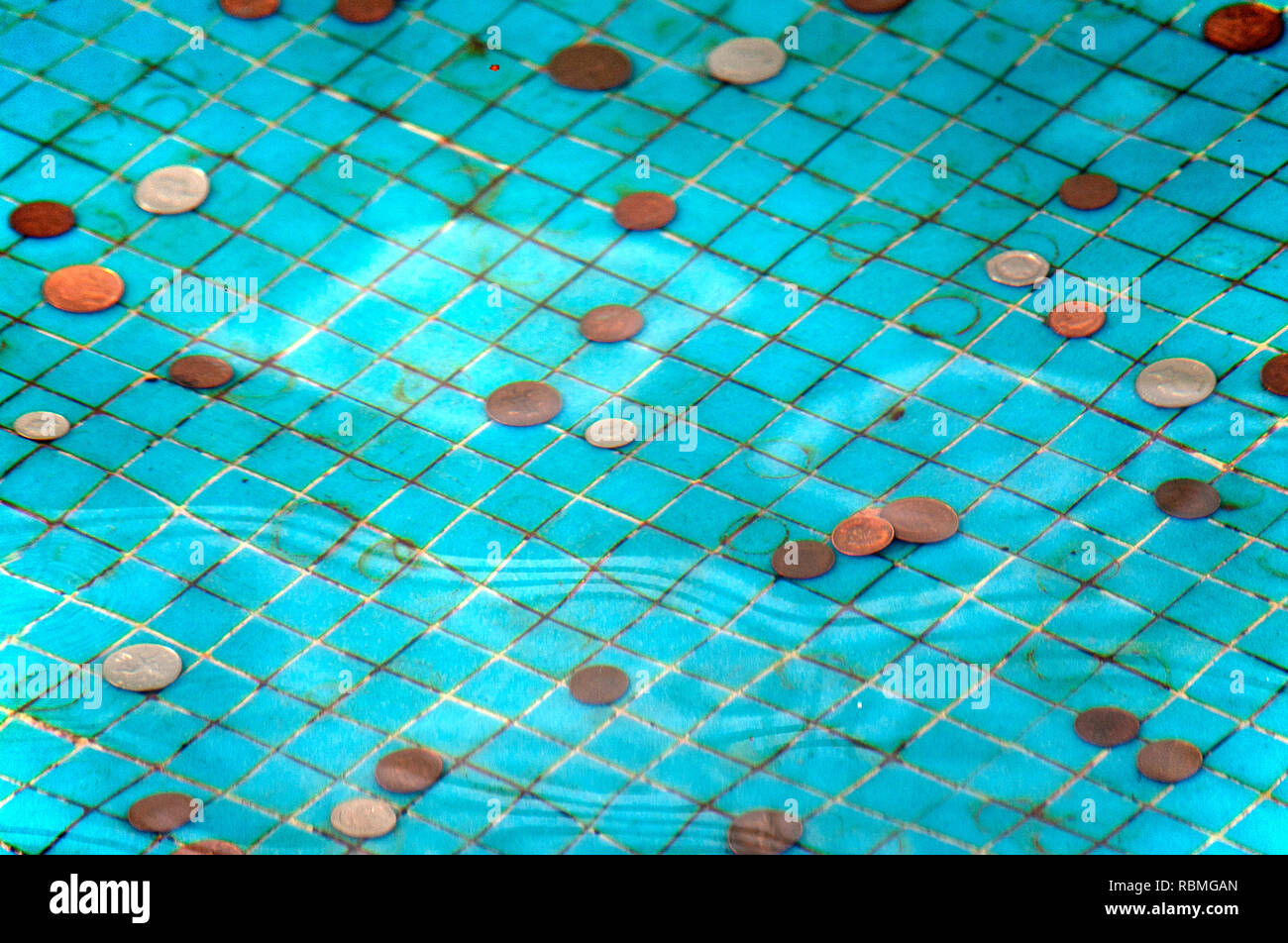 Coins in a wishing pool Stock Photo - Alamy