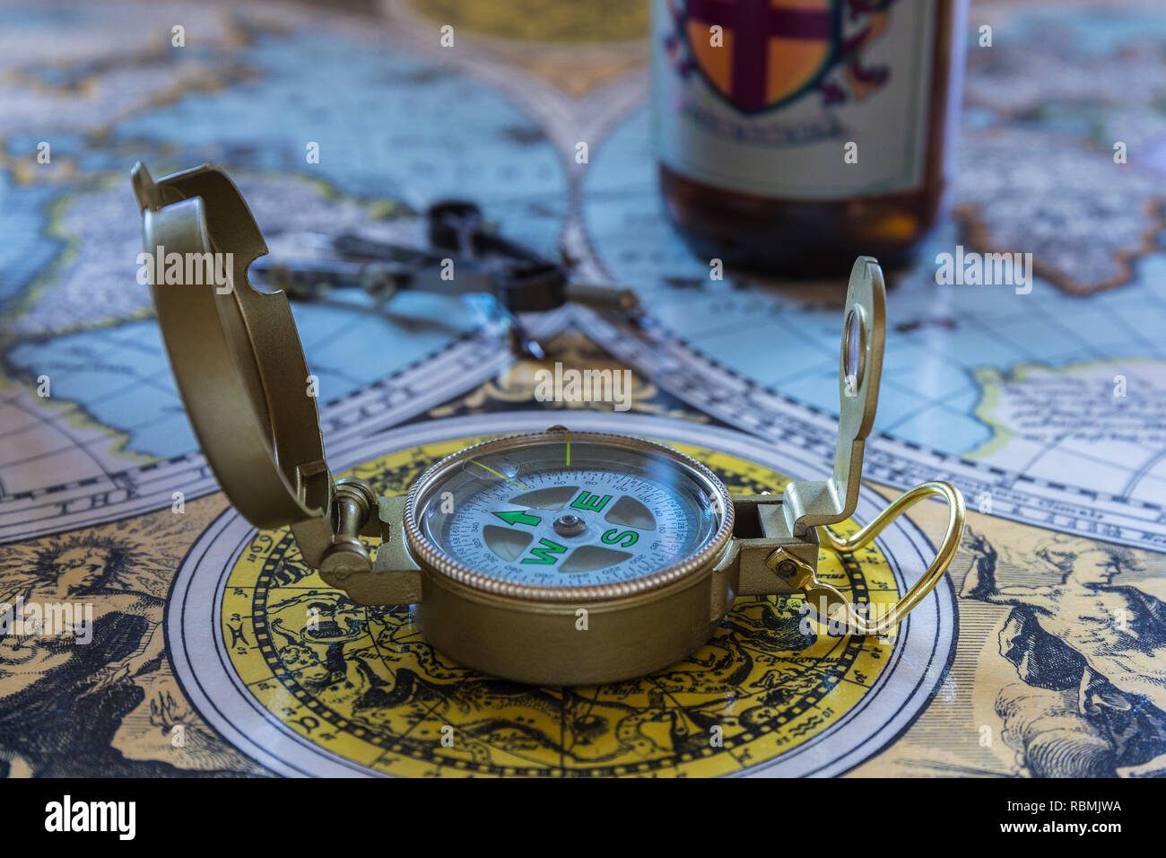 old world map with charting tools, compass, and beer bottle Stock Photo ...