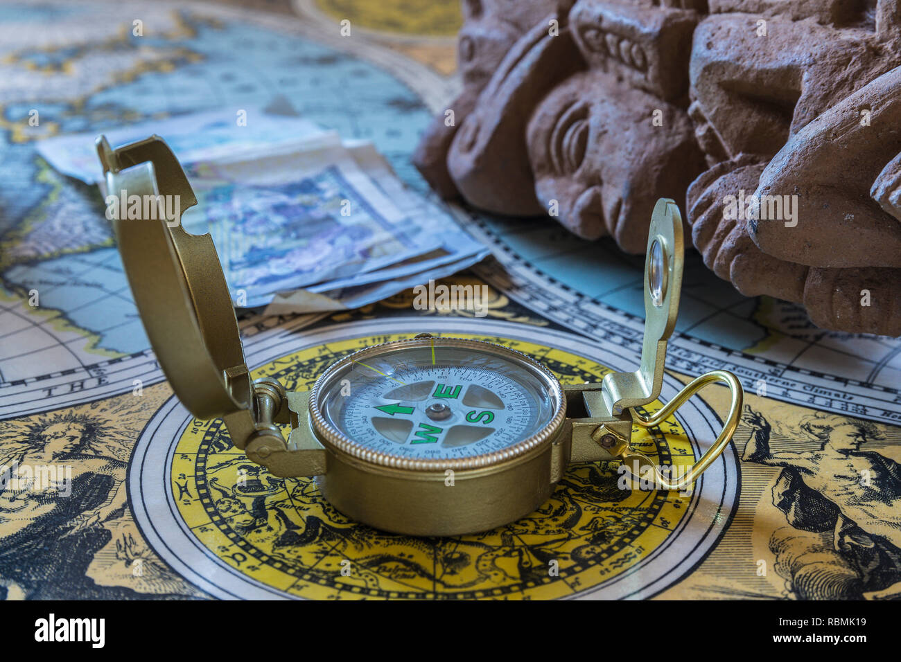 old world map with english currency, compass, and ancient clay artifact ...