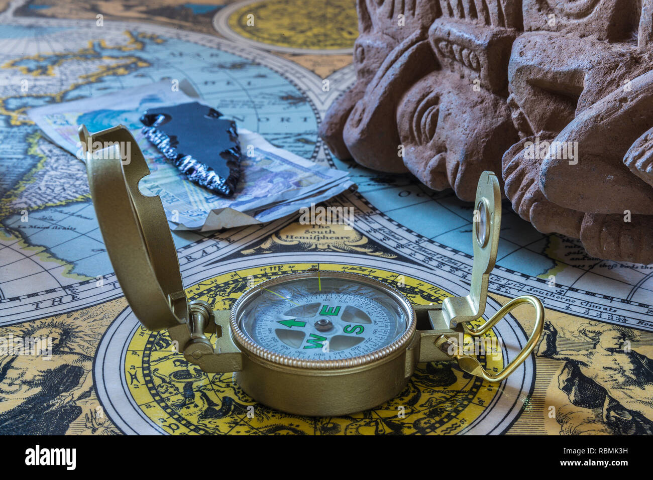 old world map with english currency, stone spear/arrow head, and ...