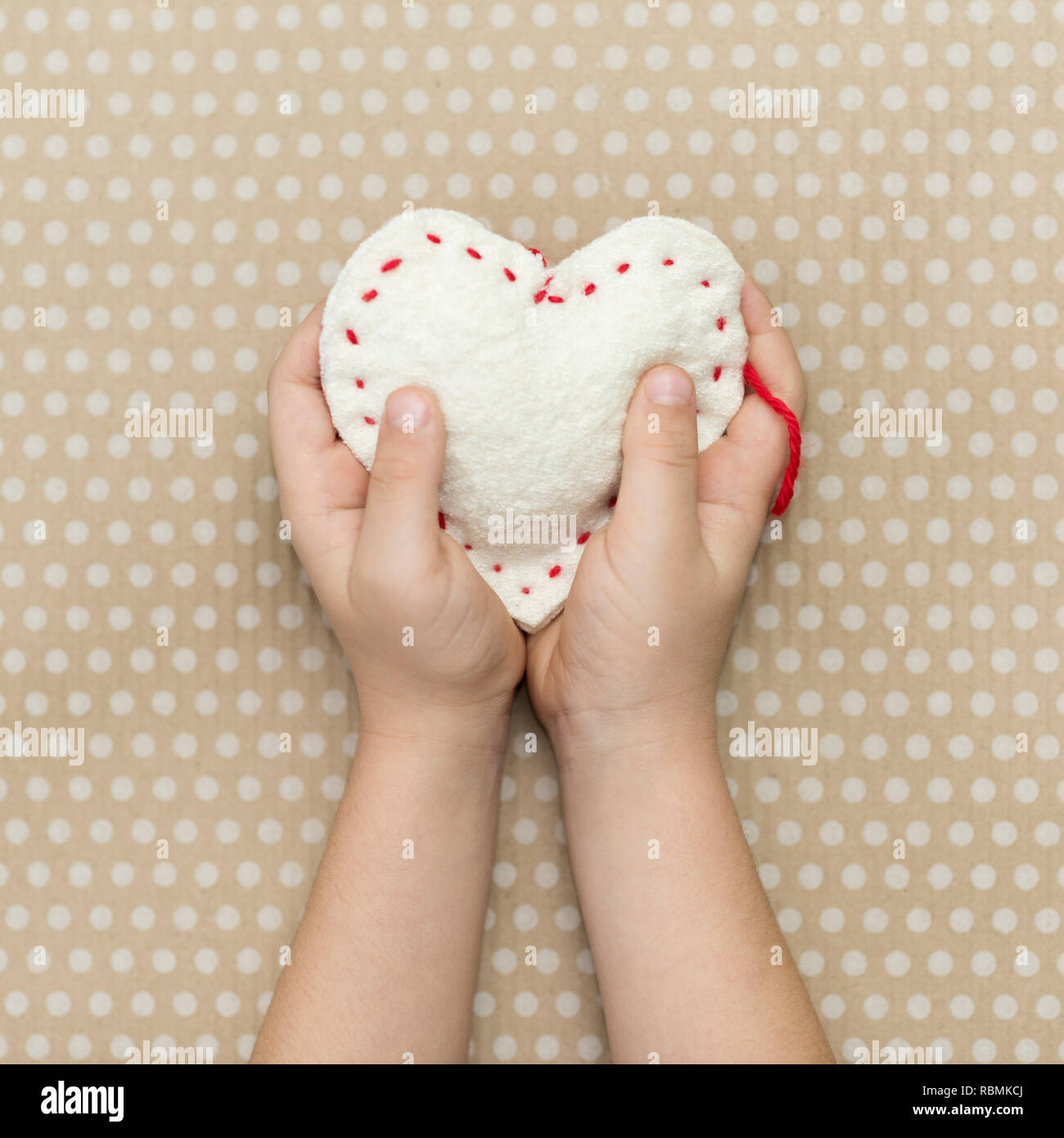 Child holding heart made hi-res stock photography and images - Alamy
