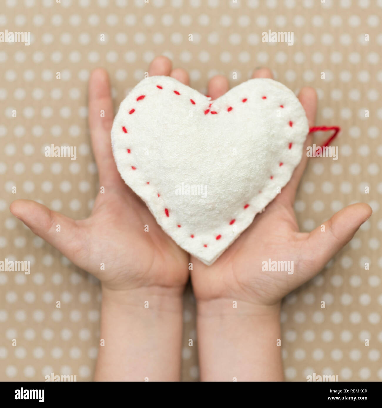 Child holding heart made hi-res stock photography and images - Alamy