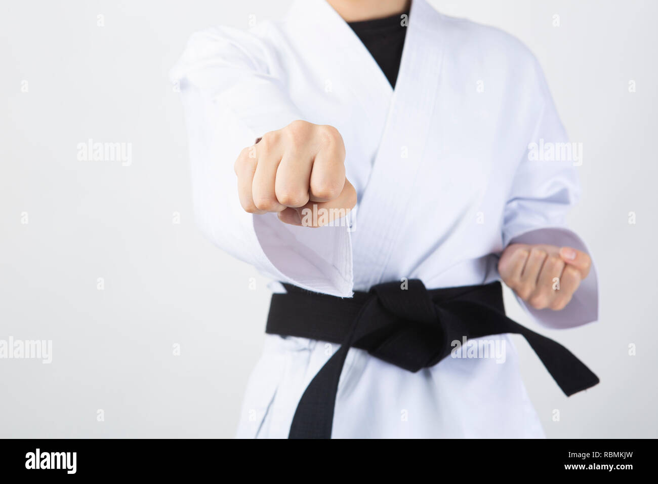 Fists of woman wearing karate suit on white background Stock Photo - Alamy