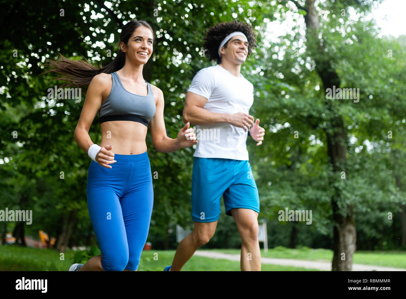 Couple jogging and running outdoors in nature Stock Photo - Alamy