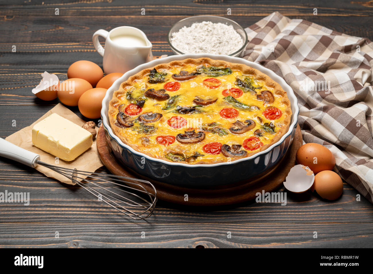 Baked homemade quiche pie in ceramic baking form, eggs and cream Stock ...