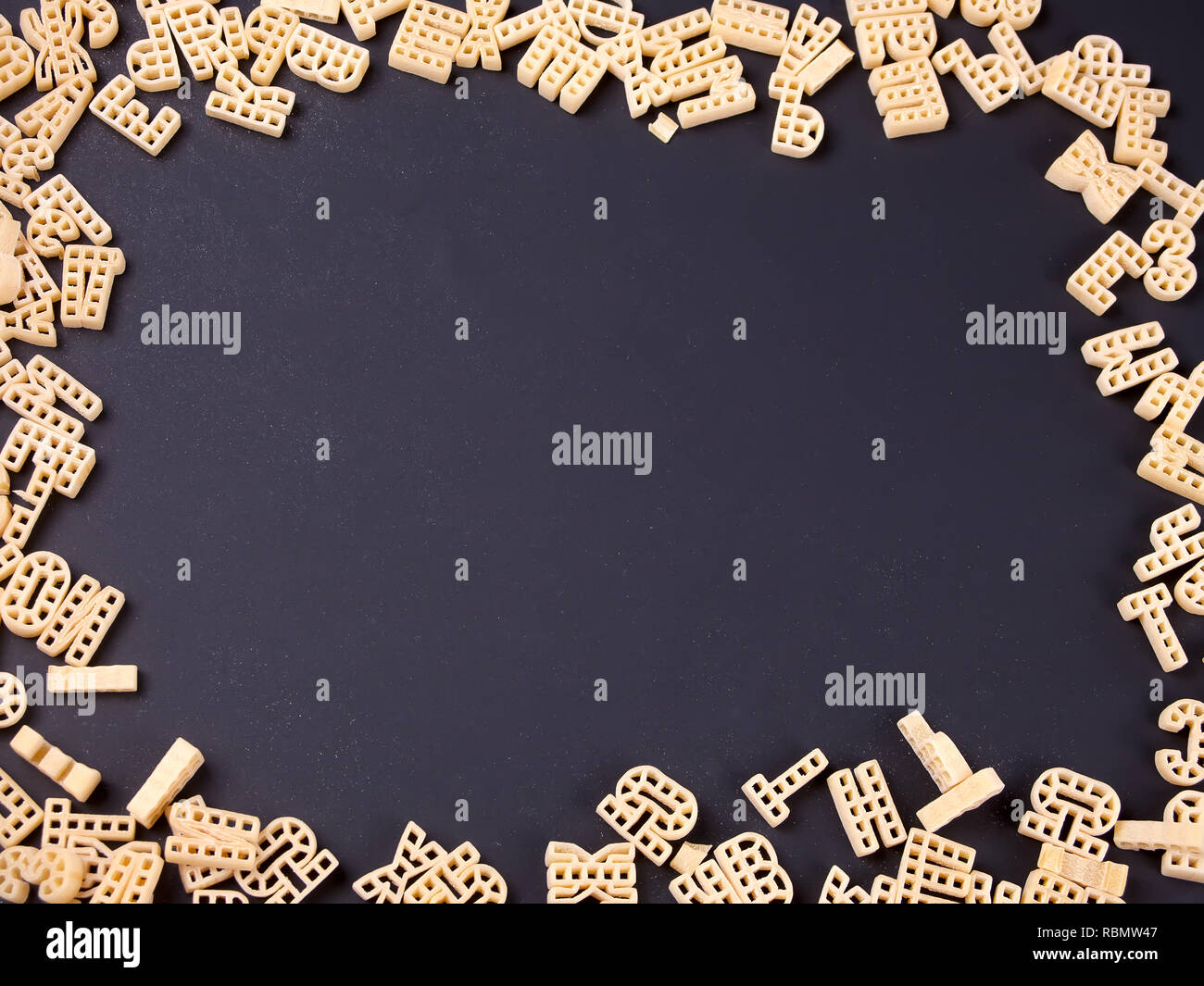 Raw macaroni frame on the black background Stock Photo - Alamy