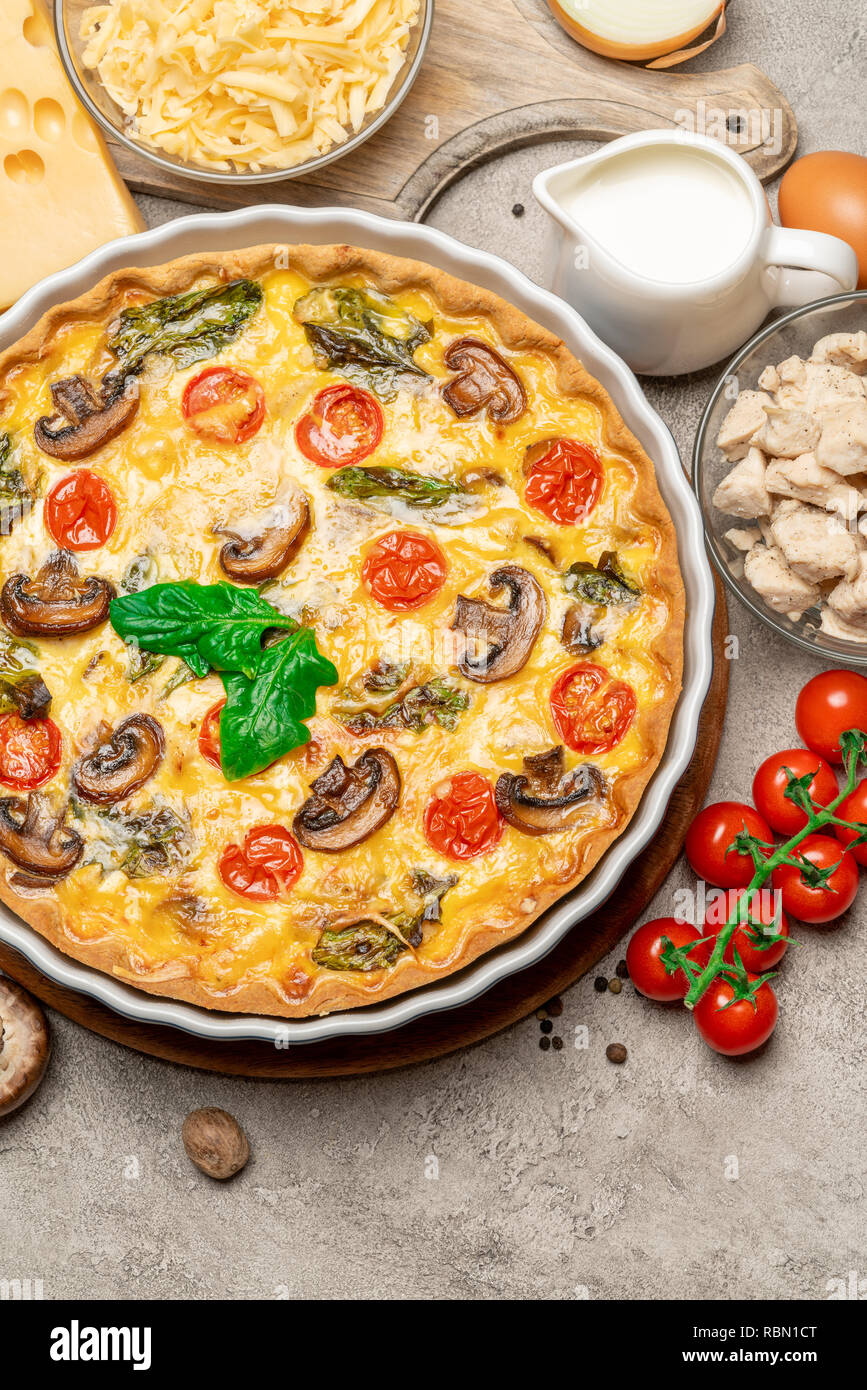 Baked homemade quiche pie in ceramic baking form, eggs and cream Stock ...