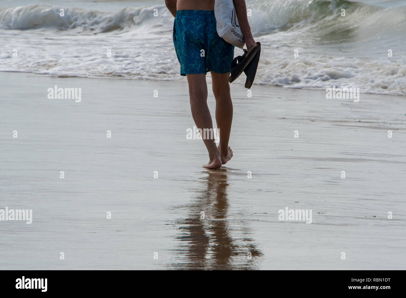 barefooted man ambling in the surge of ocean Stock Photo - Alamy