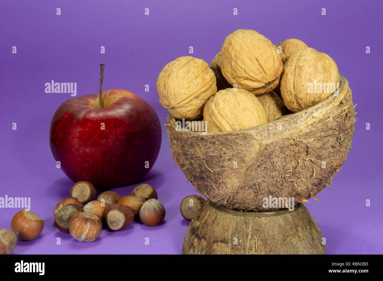 Whole common walnuts with shells in natural coconut shell cup, pile of ...
