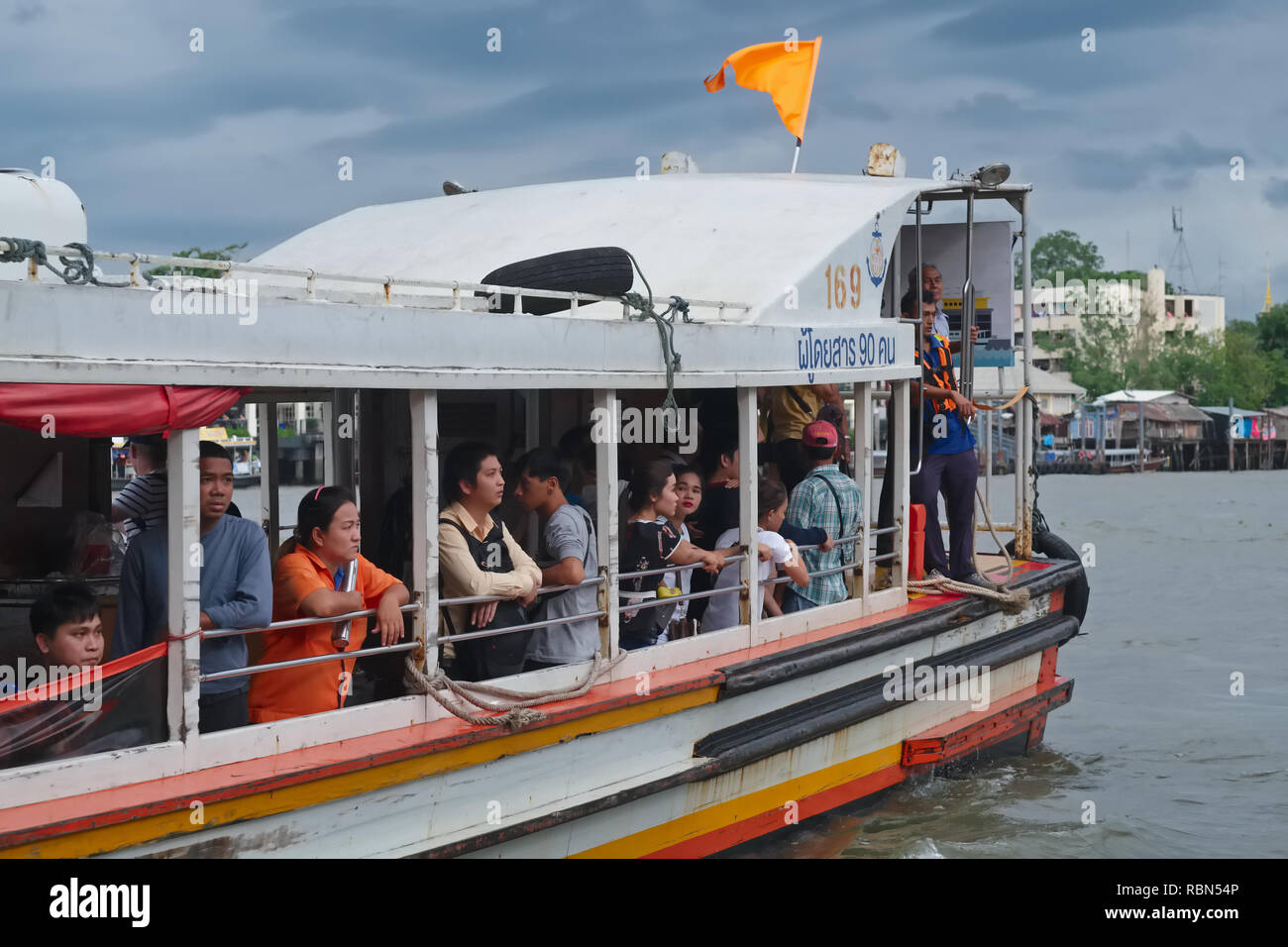 Passengers in a express boat on the Chao Phraya River in Bangkok ...