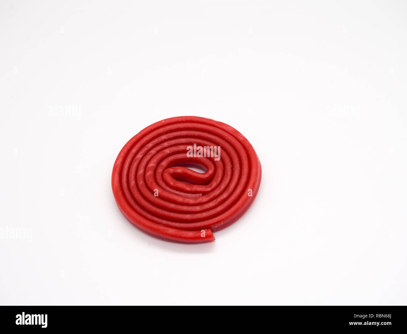 Red licorice on white background Stock Photo - Alamy