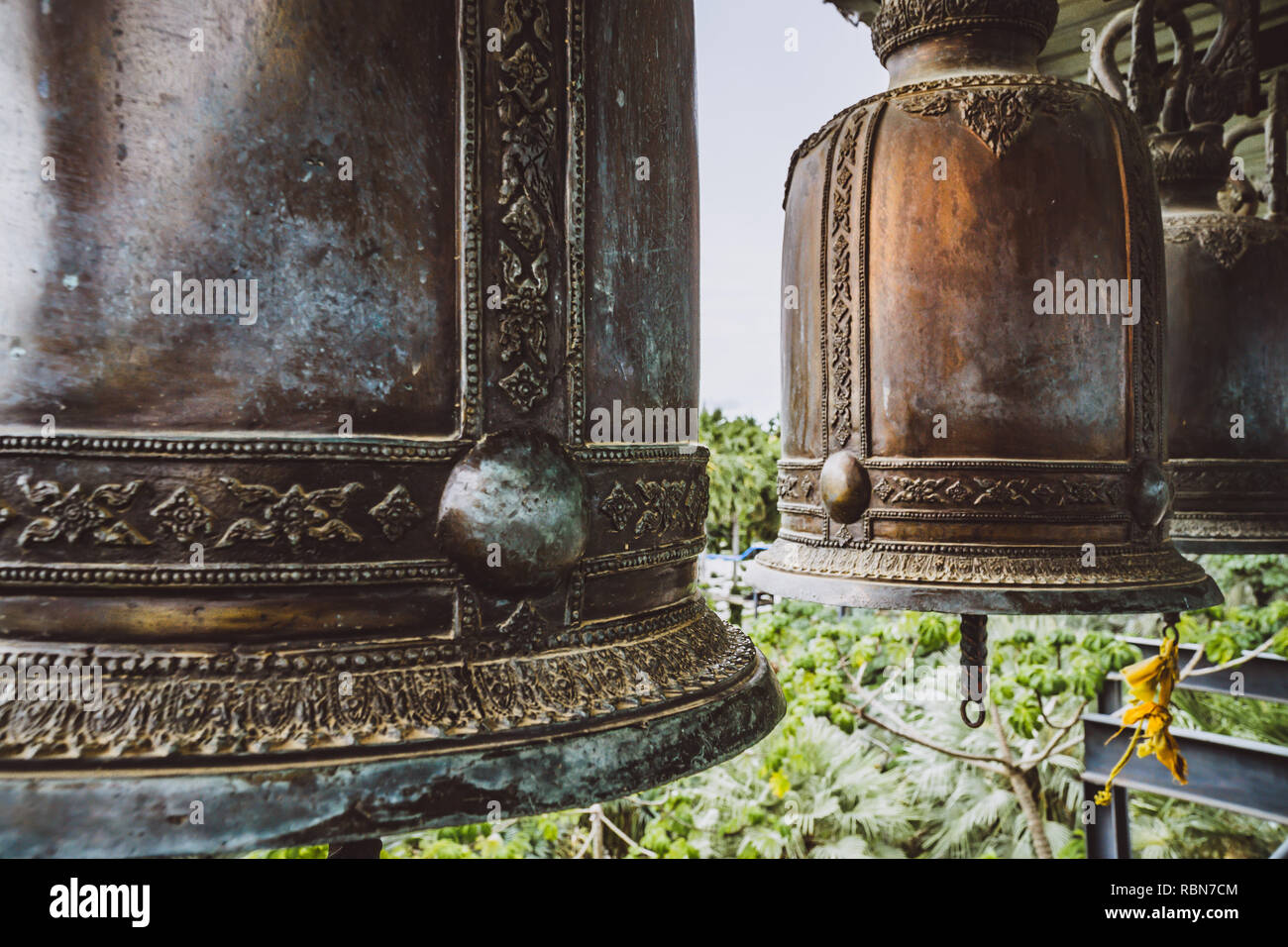 Old traditional bells hanging in an outdoor temple in Thailand Stock ...