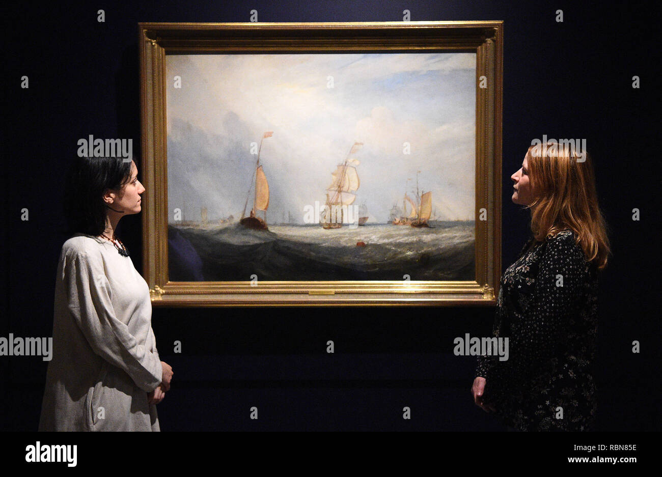 Gallery assistants with Helvoetsluys by J.M.W Turner, on display at the ...