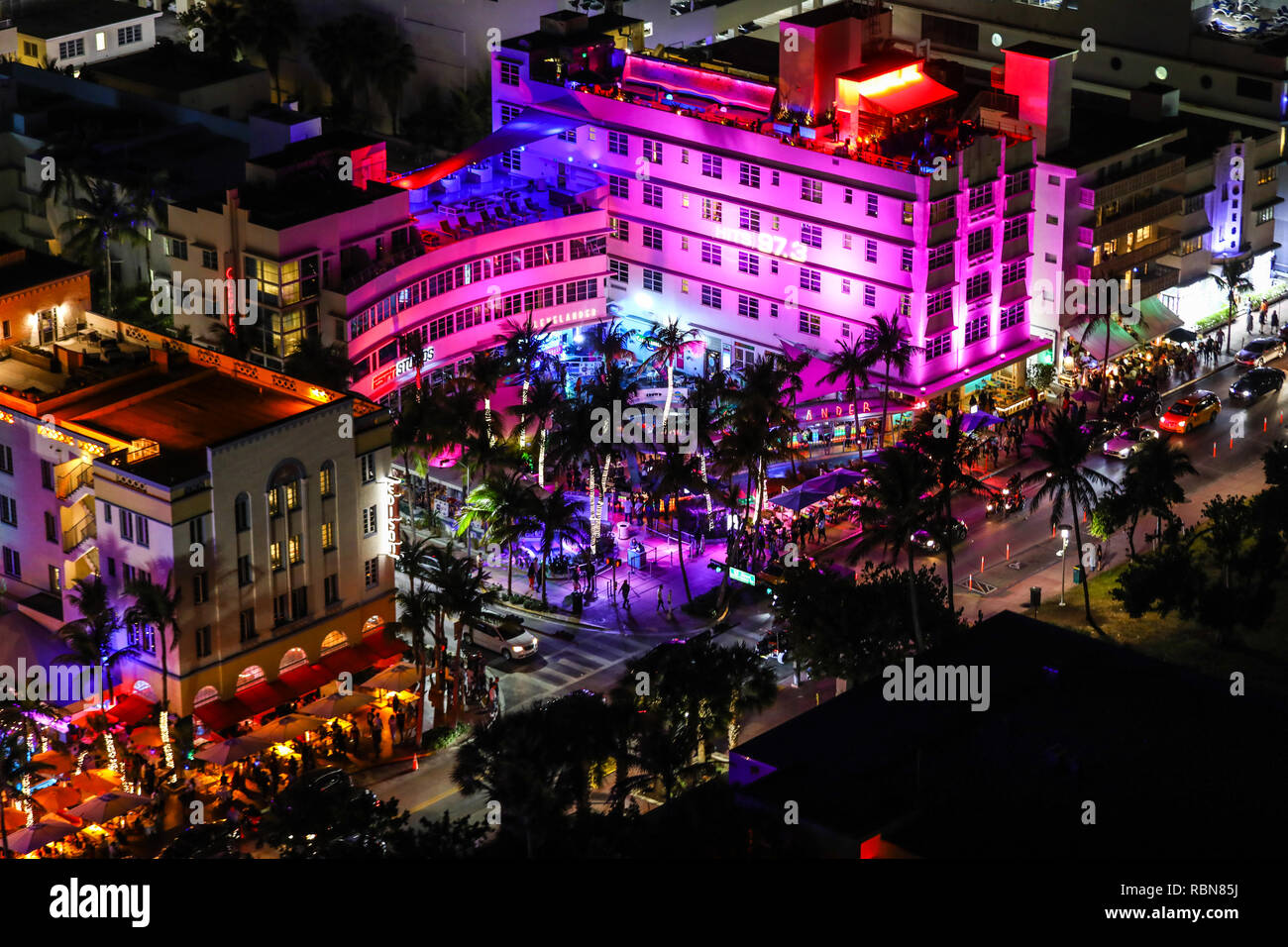 helicopter view over ocean drive, miami, on a busy night with colorful ...