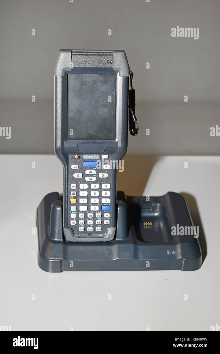 Handheld Laser Barcode Scanner Reader at Charger Dock Stock Photo - Alamy