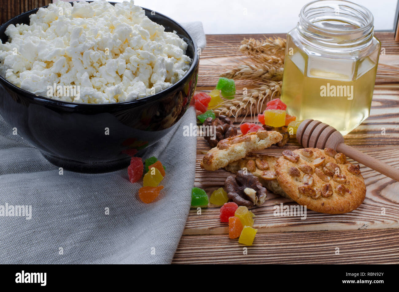 cottage cheese lie in a black plate, which stands on a wooden table ...